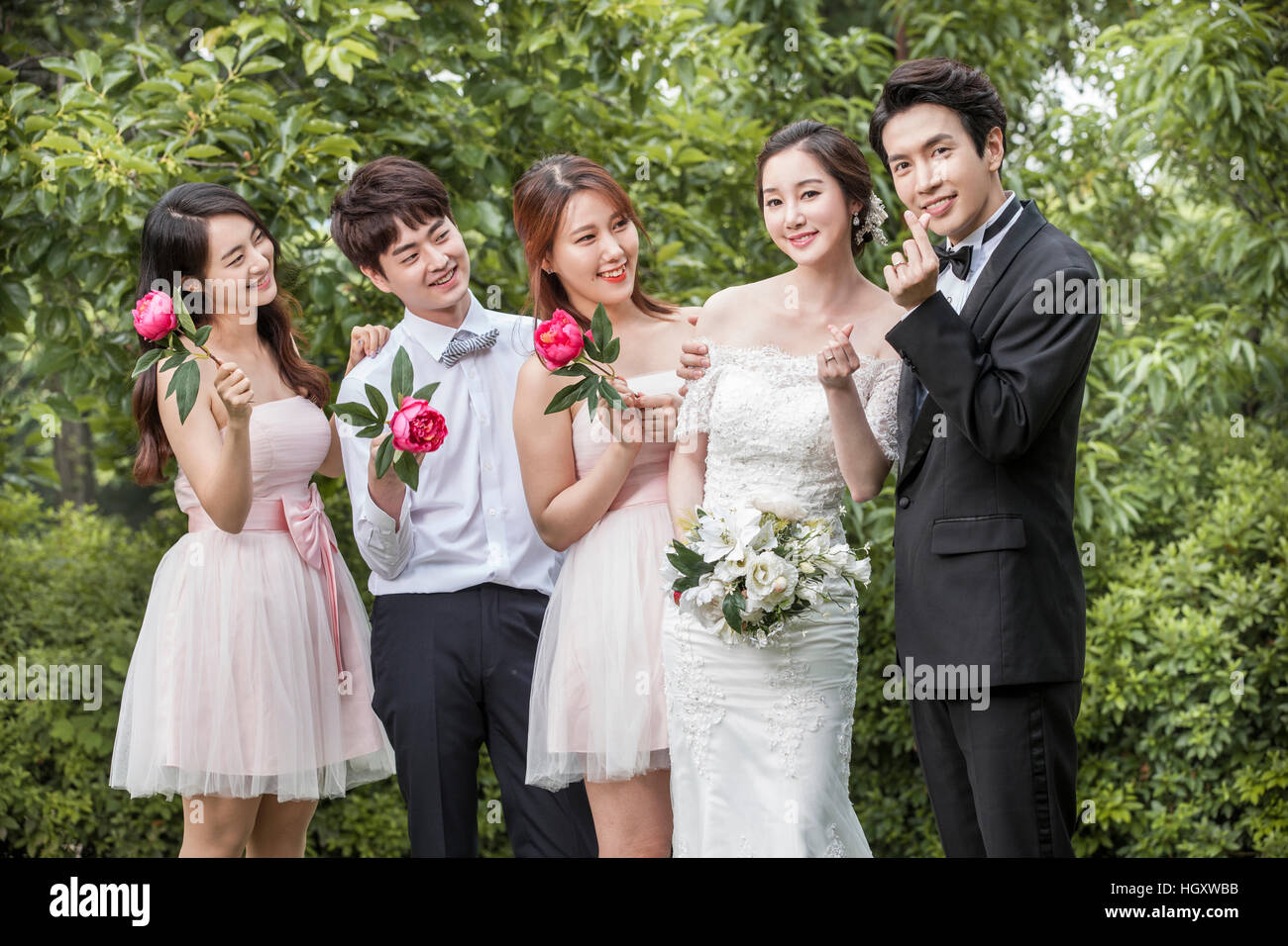 Smiling wedding couple and their friends Stock Photo - Alamy
