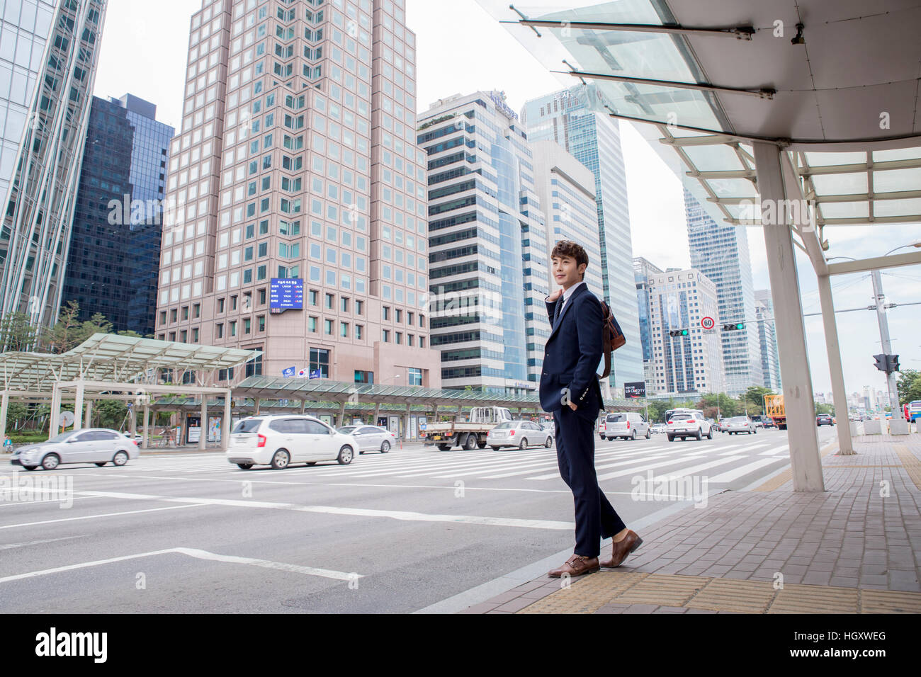 Businessman waiting for bus Stock Photo - Alamy