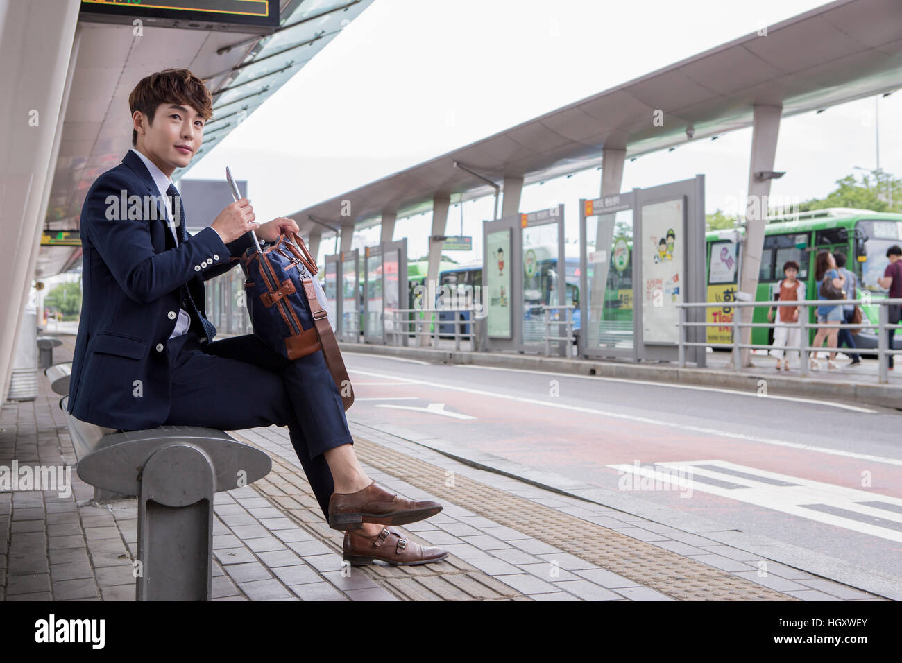 Businessman waiting for bus Stock Photo - Alamy
