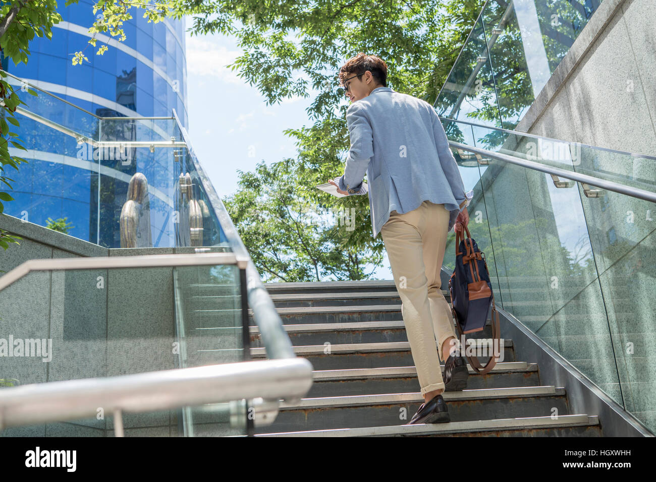 Businessman going upstairs outdoors Stock Photo - Alamy