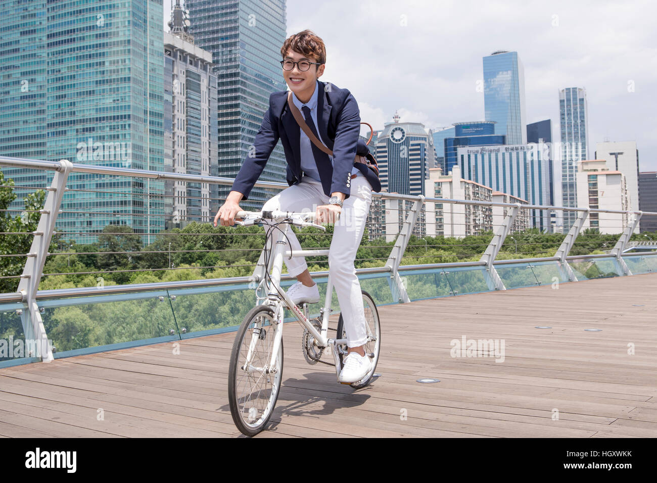 Smiling businessman riding a bicycle Stock Photo - Alamy