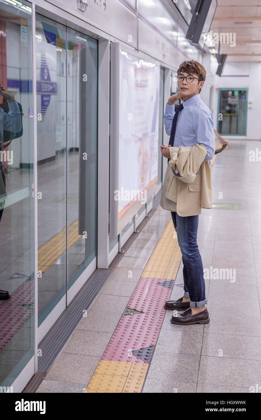 Businessman waiting for train Stock Photo - Alamy
