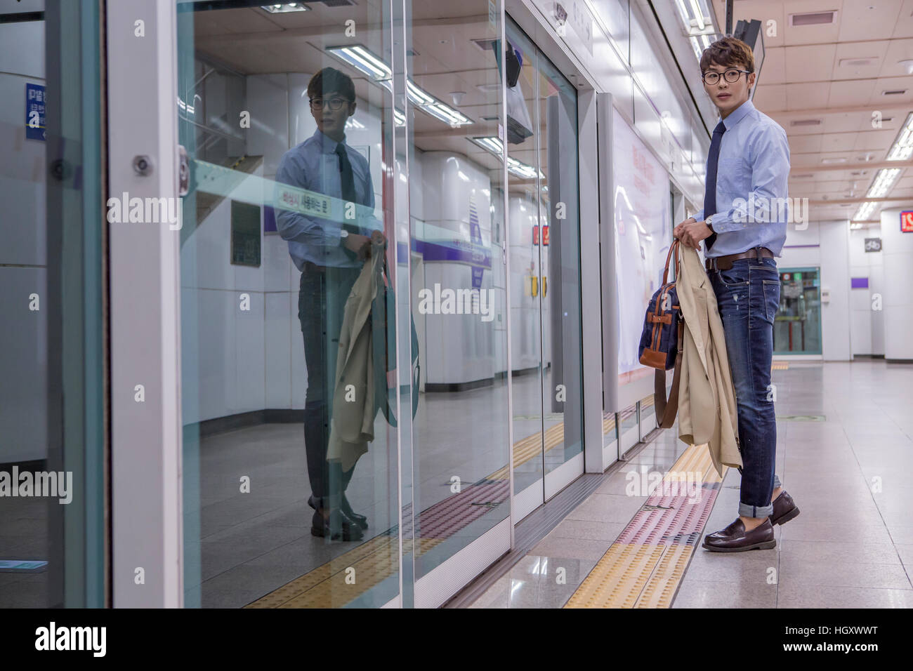 Businessman standing at subway station Stock Photo - Alamy