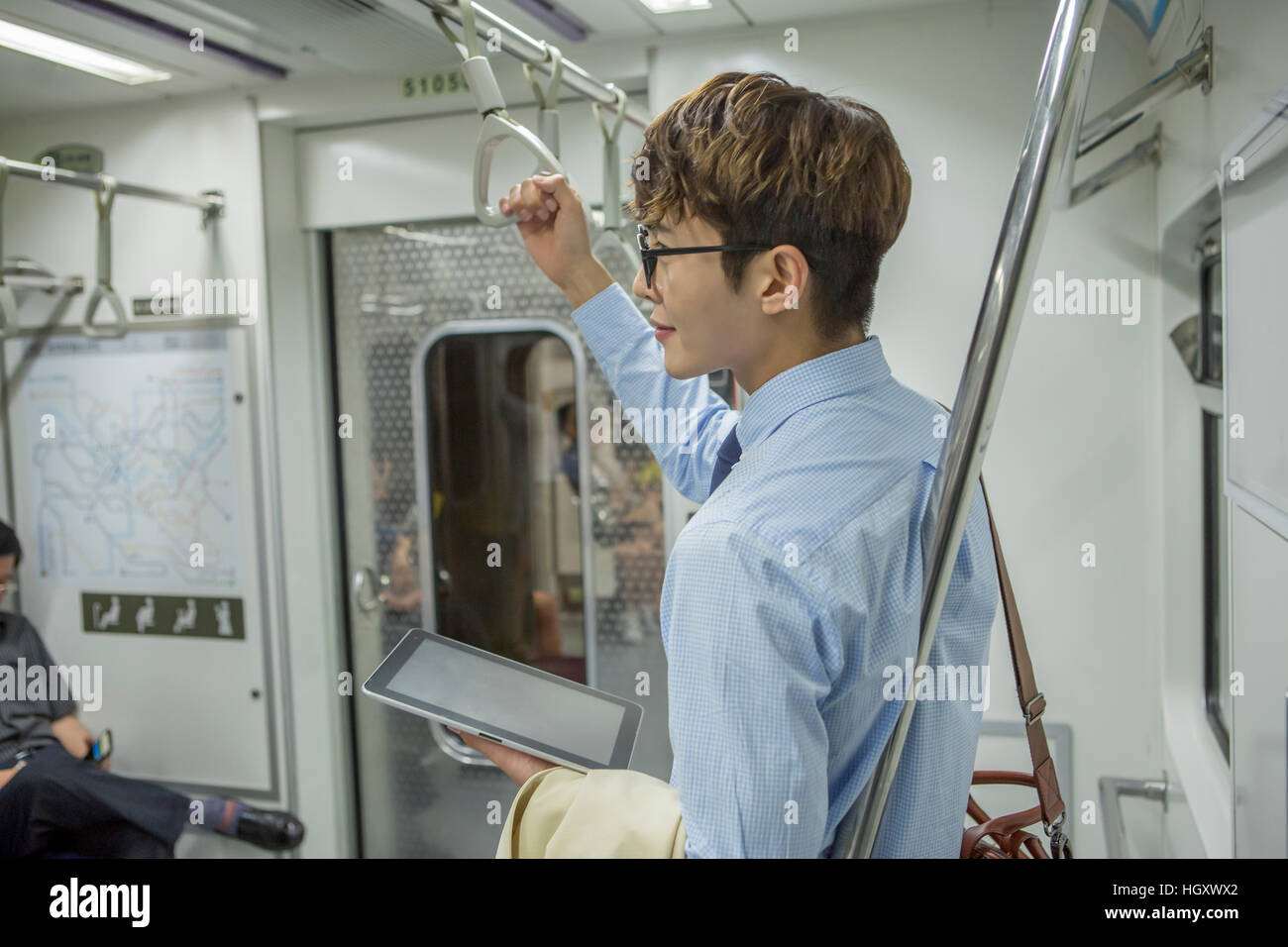 Side view of businessman using tablet in subway Stock Photo - Alamy