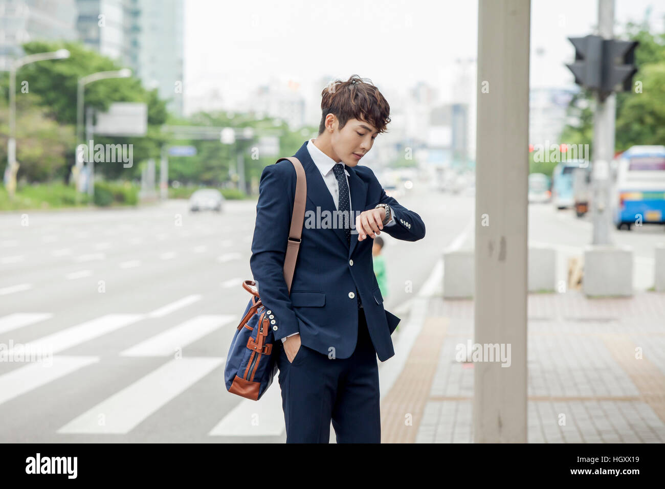 Businessman checking time outdoors Stock Photo - Alamy