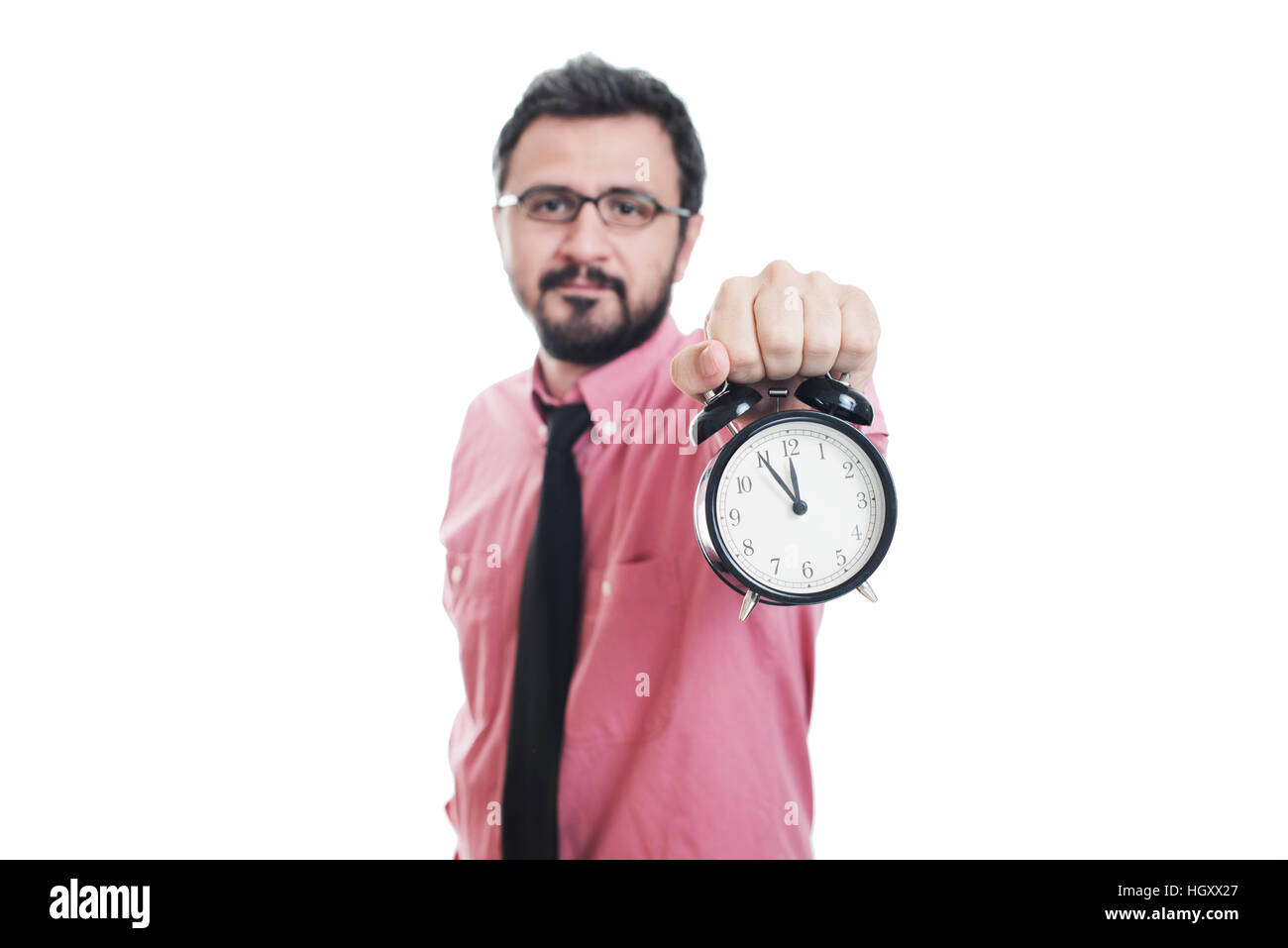 Young man showing an alarm clock Stock Photo - Alamy