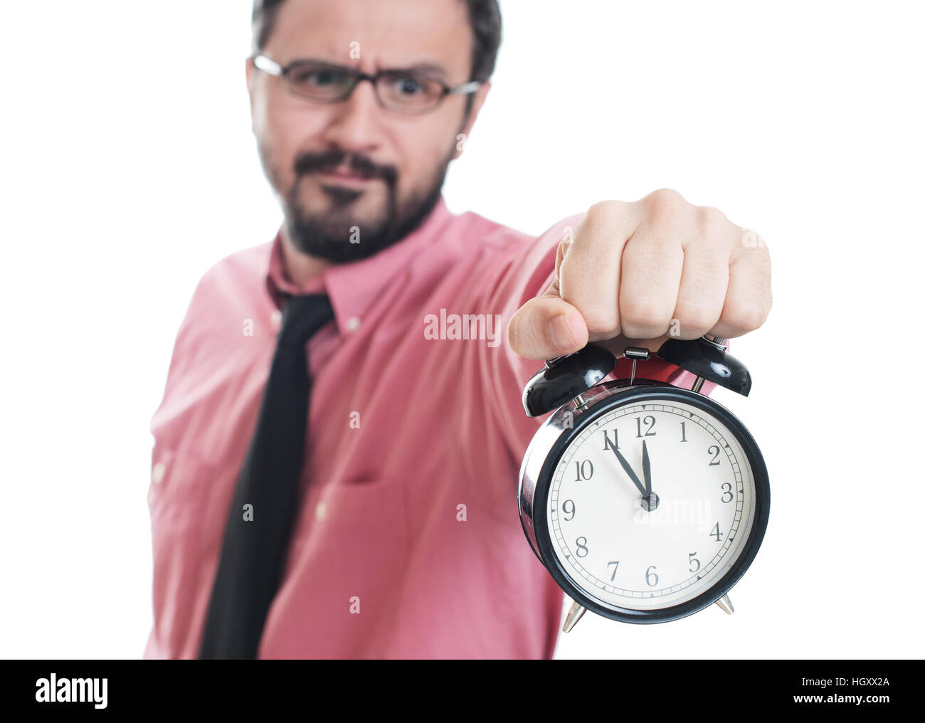 Young man showing an alarm clock Stock Photo - Alamy