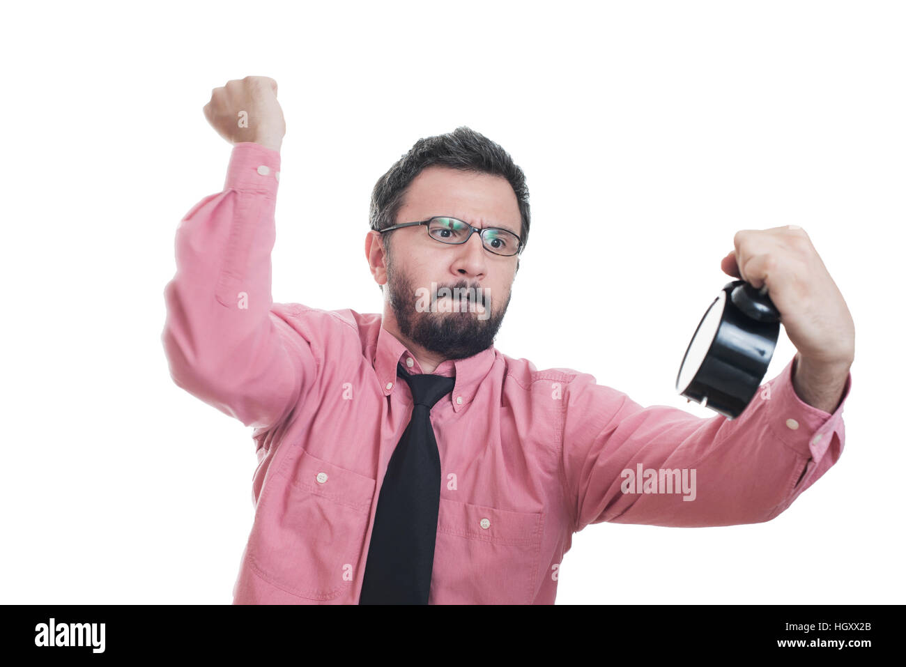 Angry young man holding alarm clock Stock Photo - Alamy