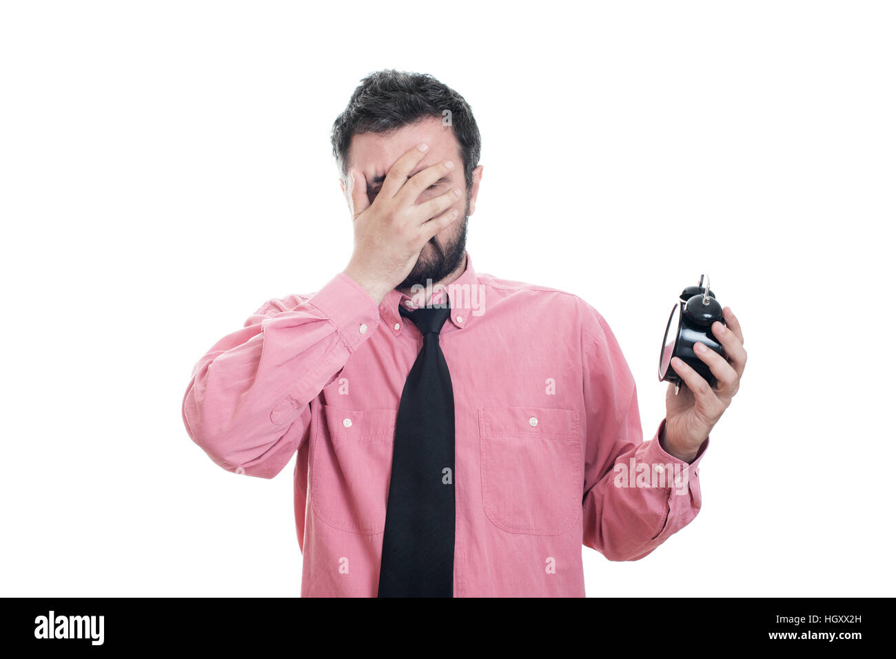 Angry young man holding alarm clock Stock Photo - Alamy