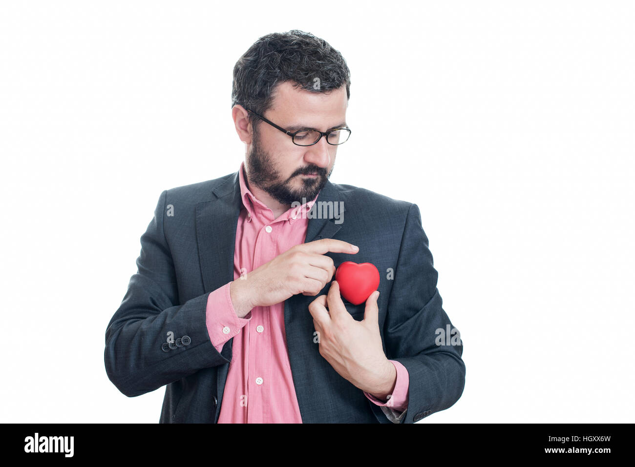 Man pulling out a red heart from the pocket of his suit Stock Photo - Alamy