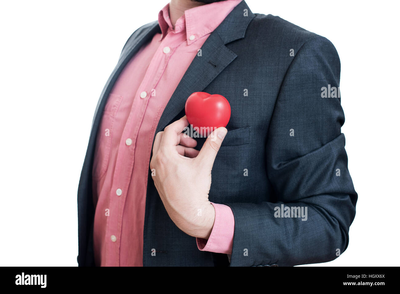 Man pulling out a red heart from the pocket of his suit Stock Photo - Alamy