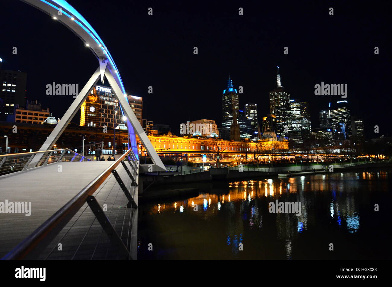 Night view of Melbourne cityscape with pedestrian bridge across the ...