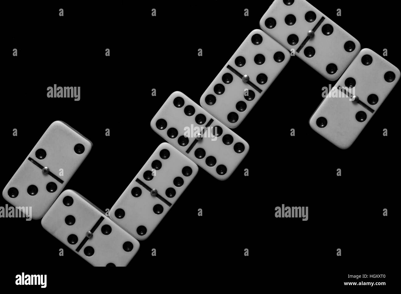 Top view of domino match. Black background, white pieces Stock Photo ...