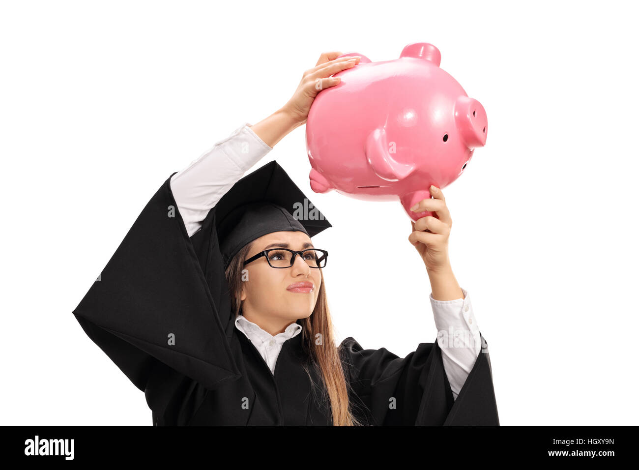 Worried graduate student shaking a piggybank isolated on white ...