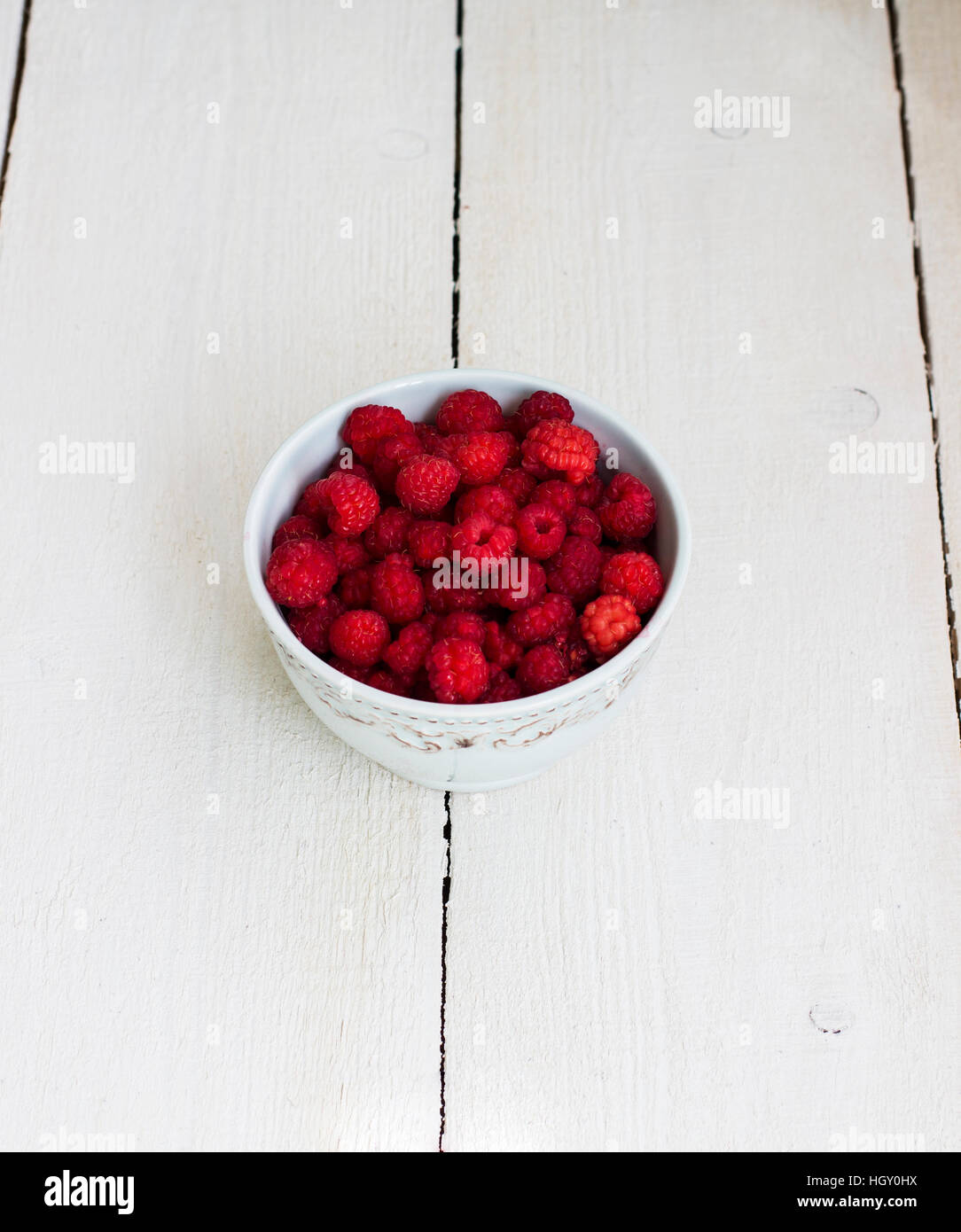 Turquoise cup with raspberry Stock Photo - Alamy
