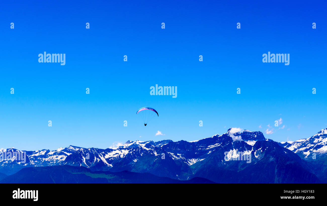 Paragliders soaring high over the alps in Verbier, Switzerland in the ...