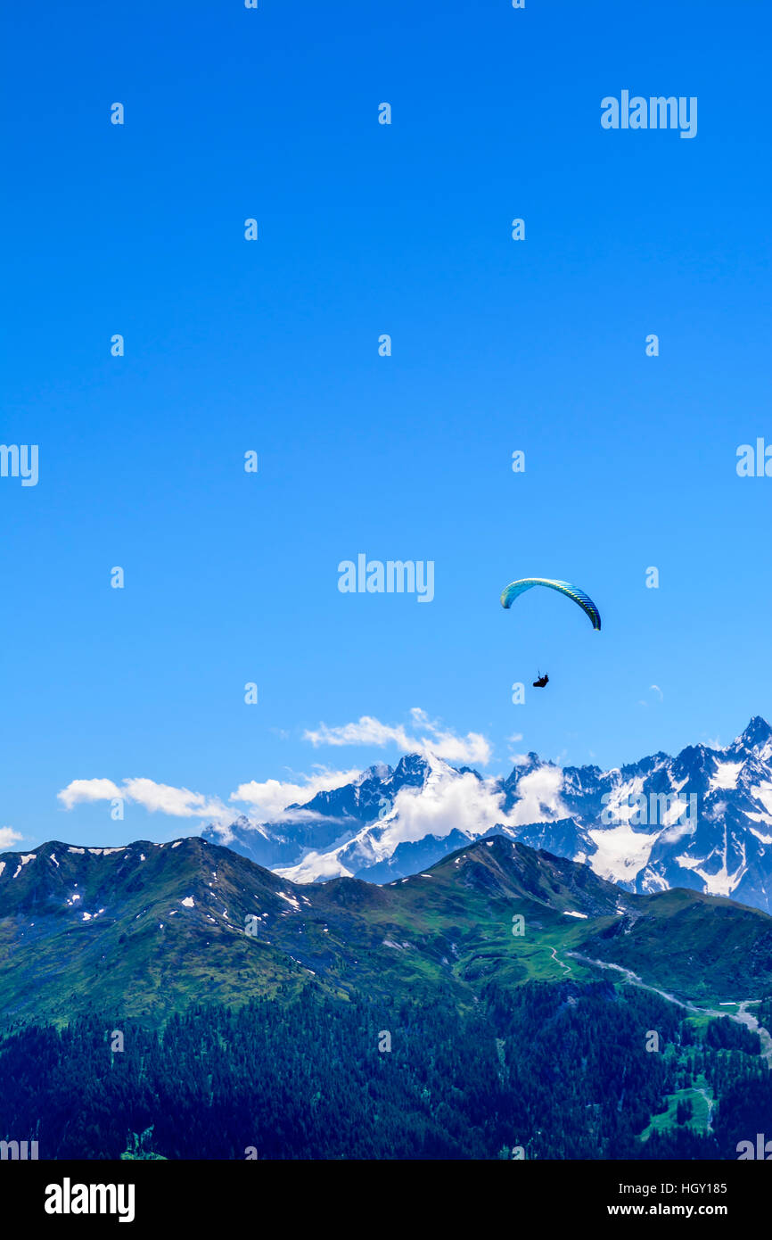 Paragliders soaring high over the alps in Verbier, Switzerland in the ...