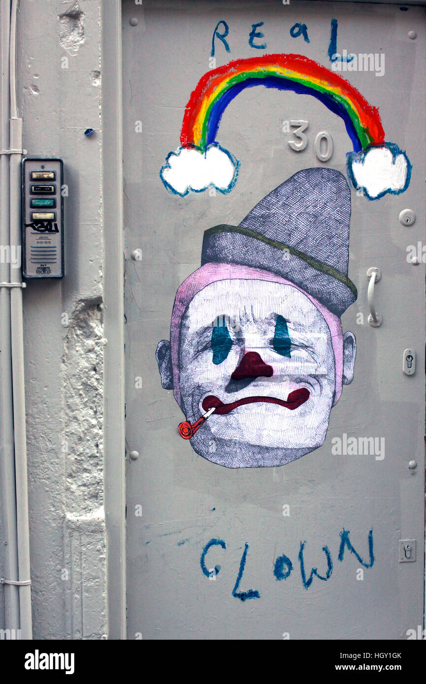 Street art featuring a clown on a door in east London Stock Photo - Alamy