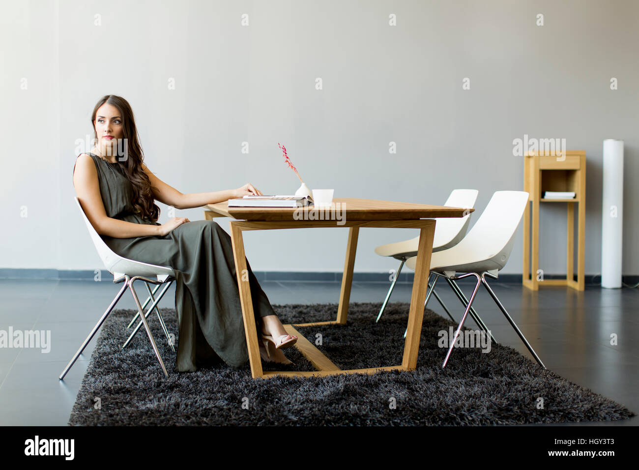 Woman reading sitting table hi-res stock photography and images - Alamy