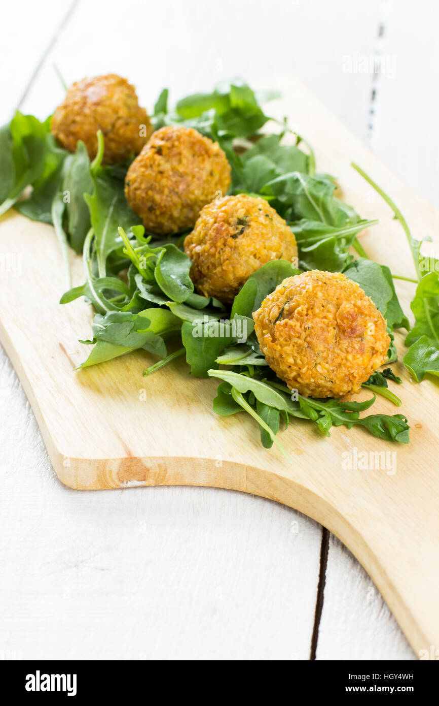 Falafel from chick-pea on a wooden board with arugula Stock Photo - Alamy