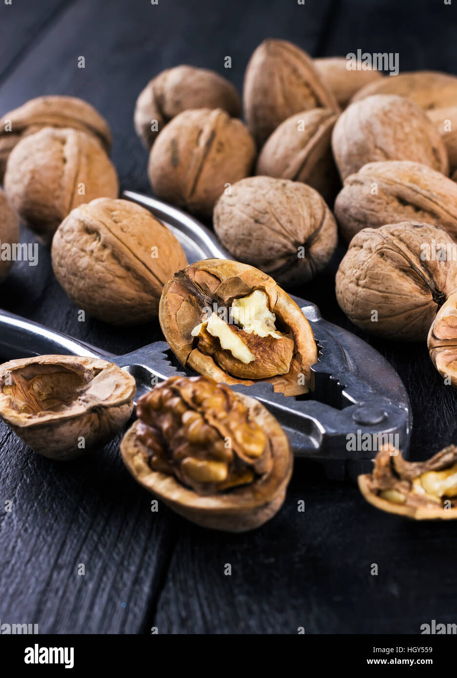Walnut kernels and whole walnuts on wooden background Stock Photo - Alamy