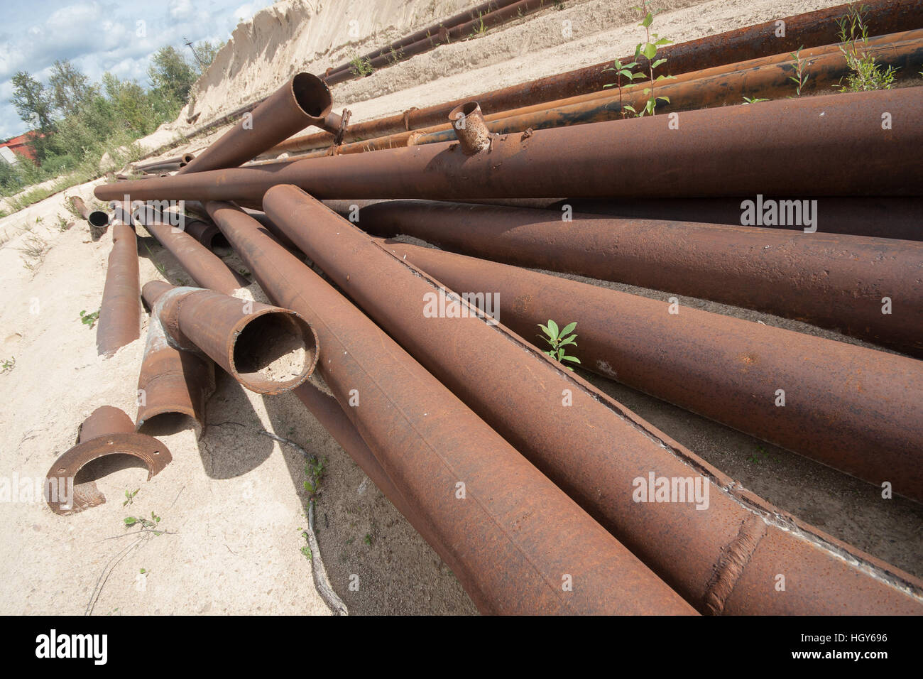 rusty pipes left in field Stock Photo - Alamy
