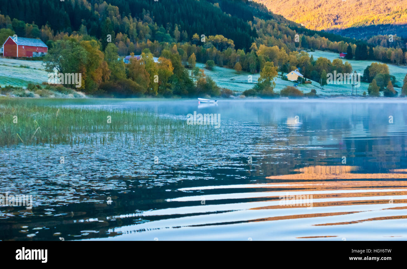 the morning fog hides the small boat on the shore of a lake. Oppheim ...