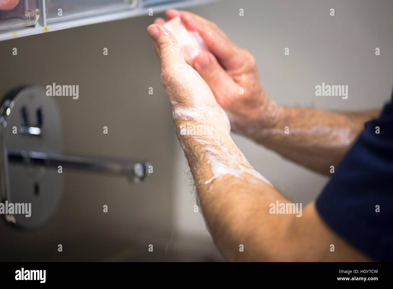 Surgeon in hospital surgery washing handsin sterile uniform "scrubs ...