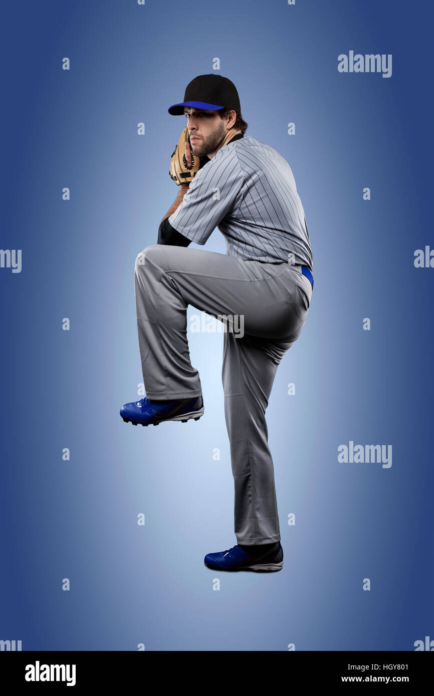 Pitcher Baseball Player on a blue Uniform on blue background Stock ...