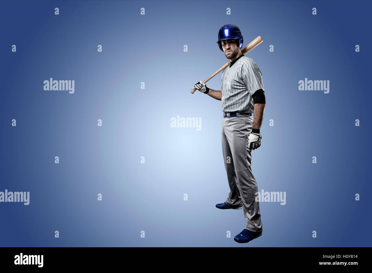 Baseball Player on a Blue Uniform on blue background Stock Photo - Alamy