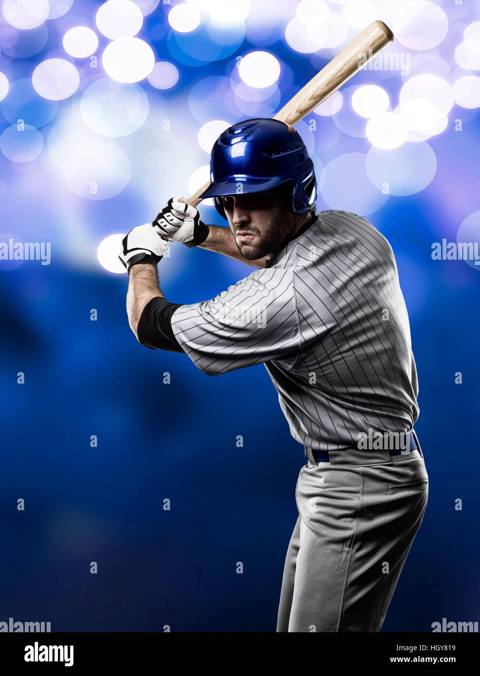 Baseball Player on a Blue Uniform on blue lights background Stock Photo ...