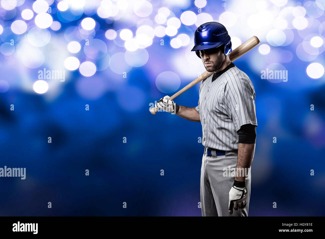 Baseball Player on a Blue Uniform on blue lights background Stock Photo ...