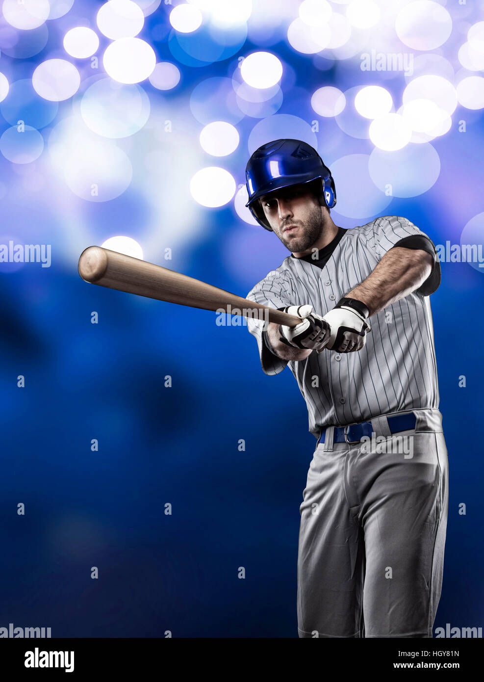 Baseball Player on a Blue Uniform on blue lights background Stock Photo ...