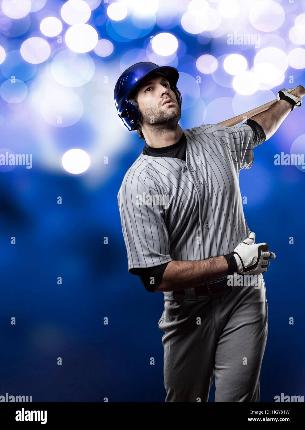 Baseball Player on a Blue Uniform on blue lights background Stock Photo ...