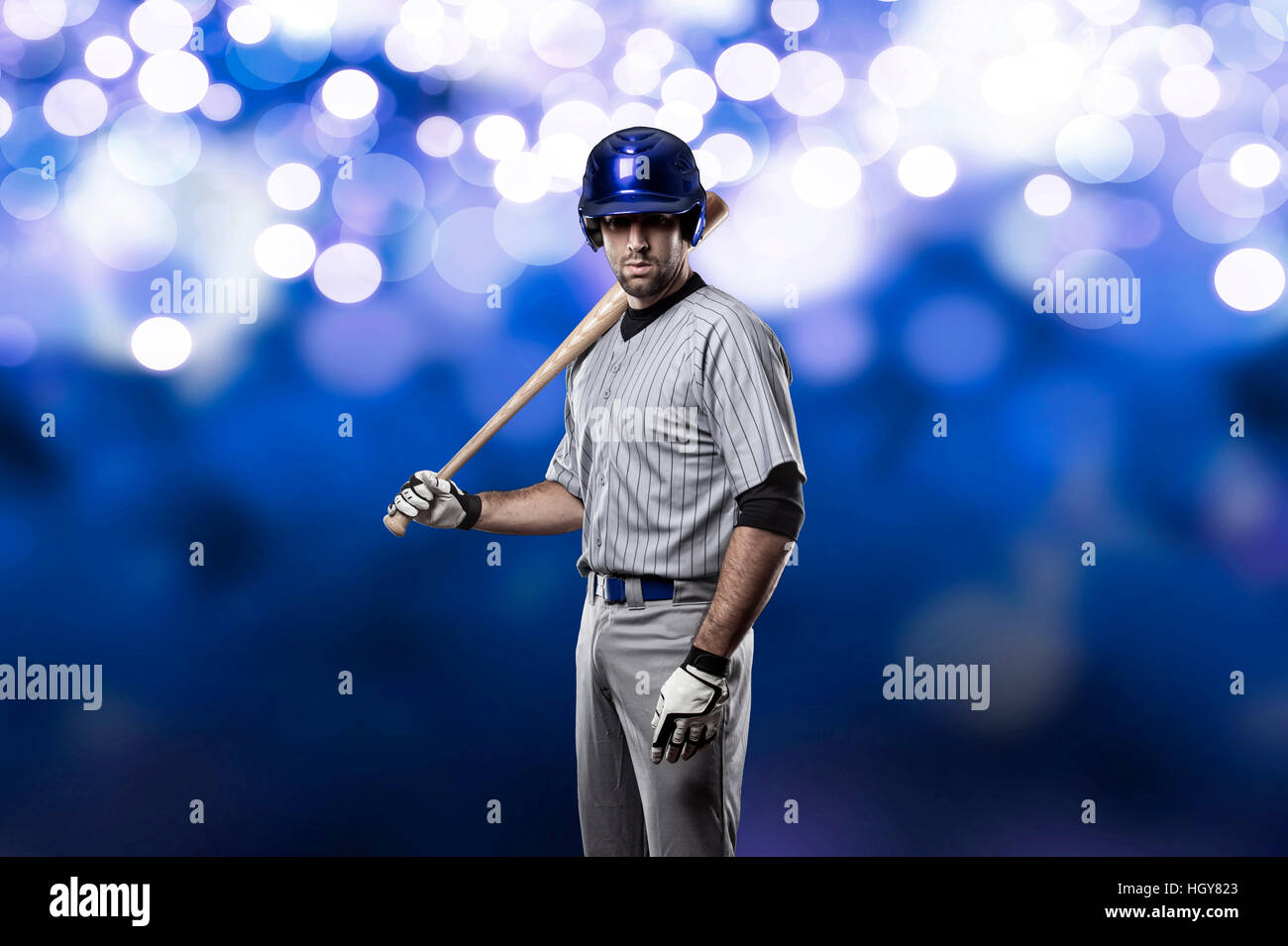 Baseball Player on a Blue Uniform on blue lights background Stock Photo ...