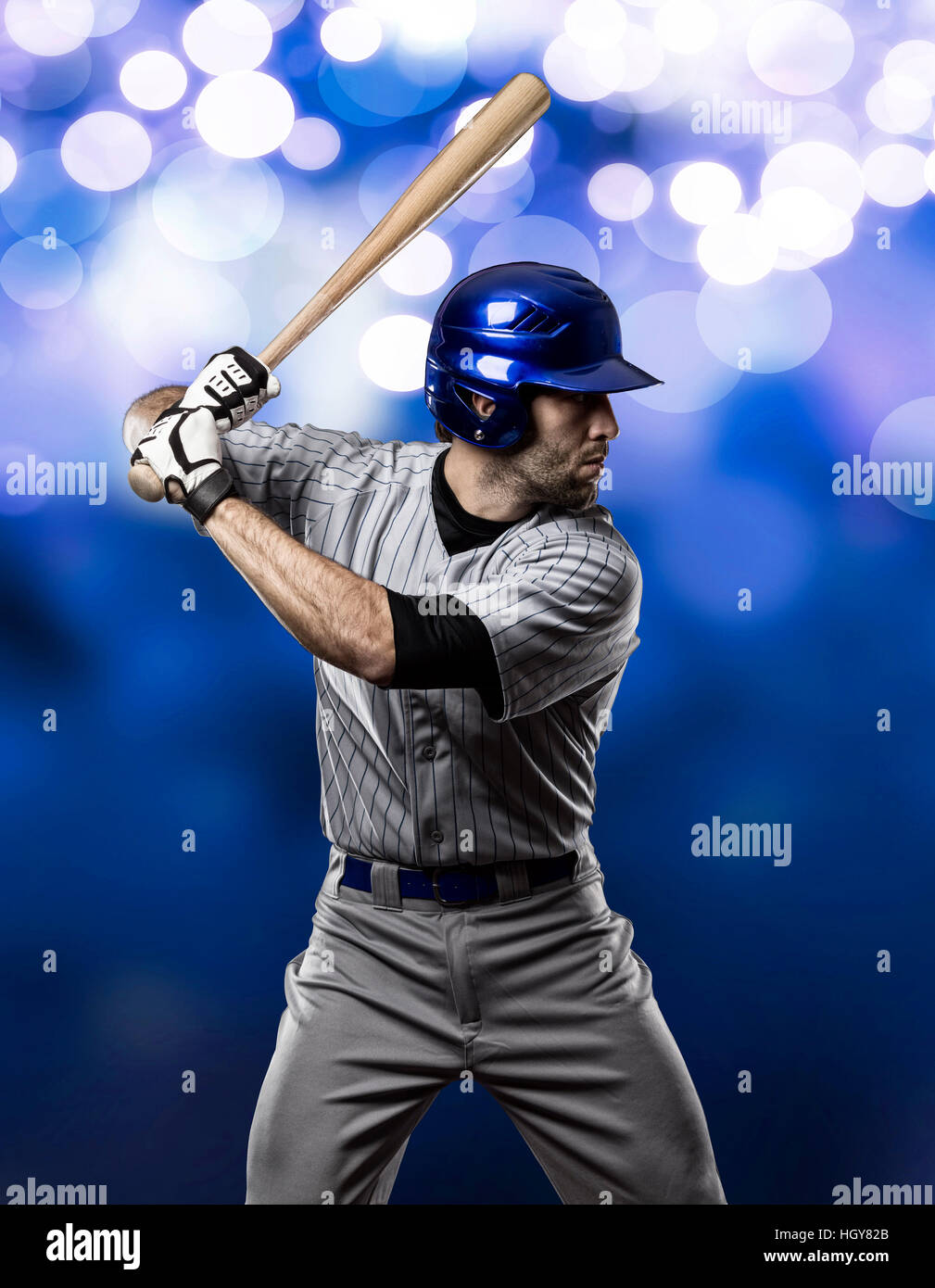 Baseball Player on a Blue Uniform on blue lights background Stock Photo ...