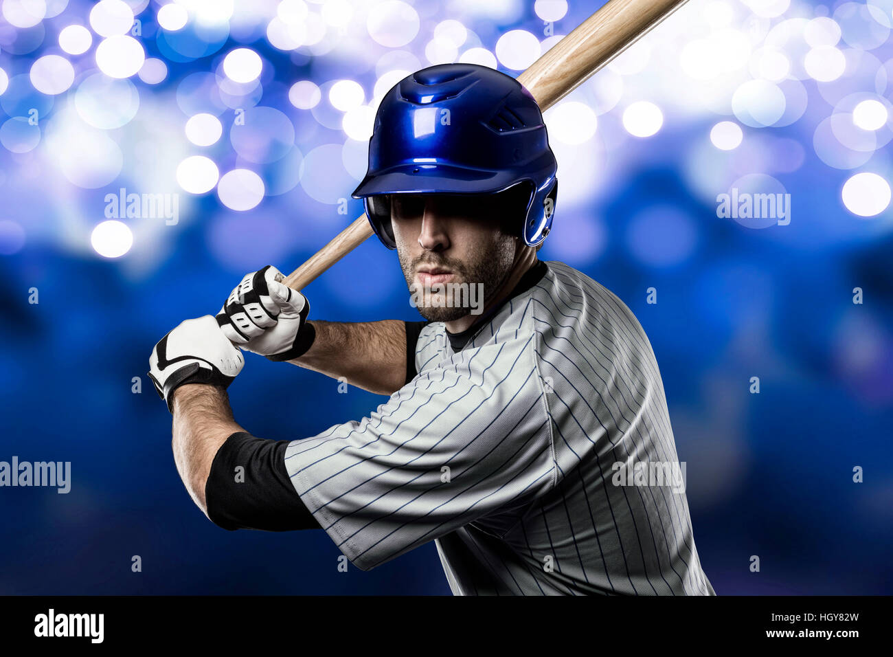 Baseball Player on a Blue Uniform on blue lights background Stock Photo ...