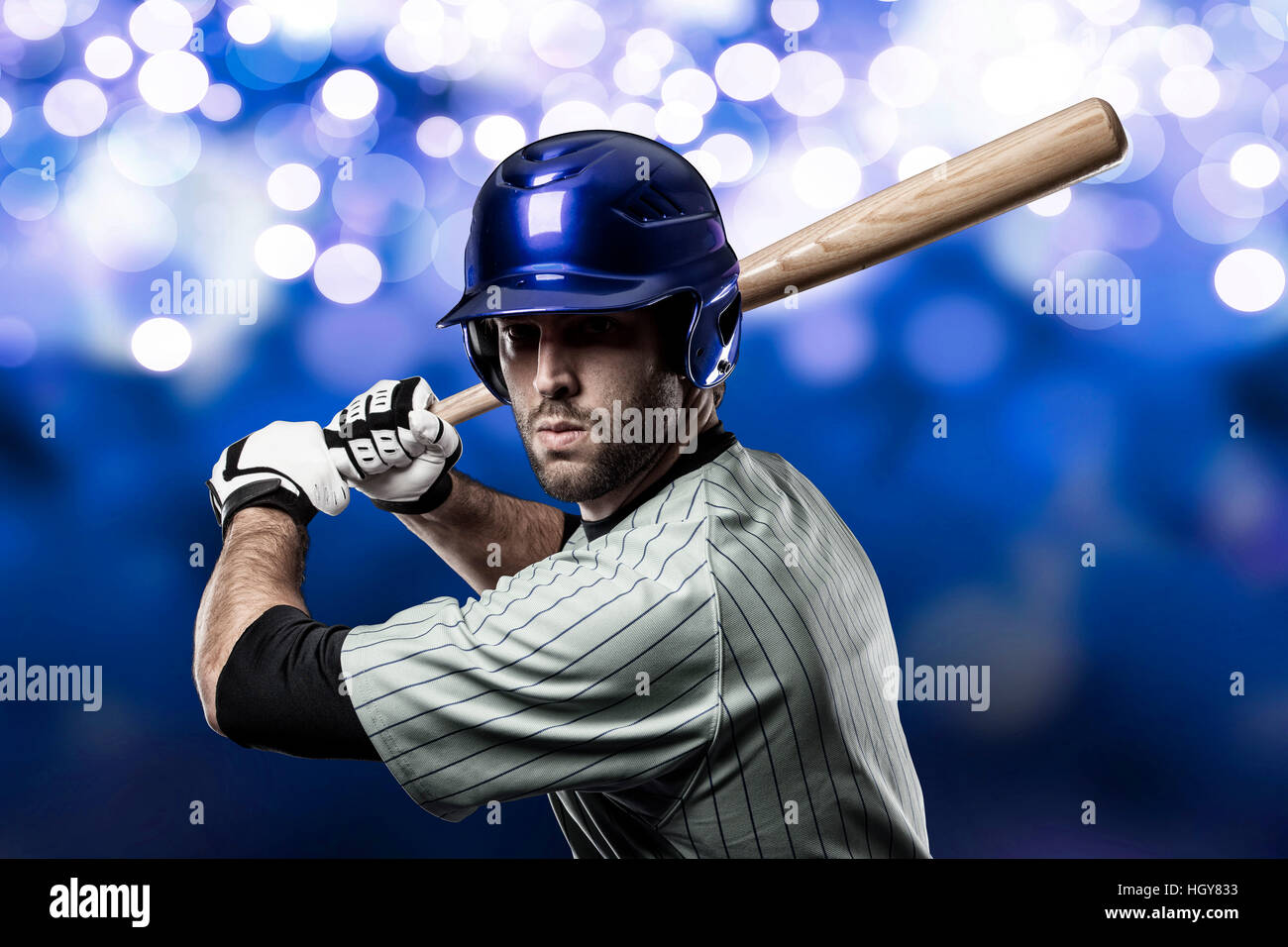 Baseball Player on a Blue Uniform on blue lights background Stock Photo ...