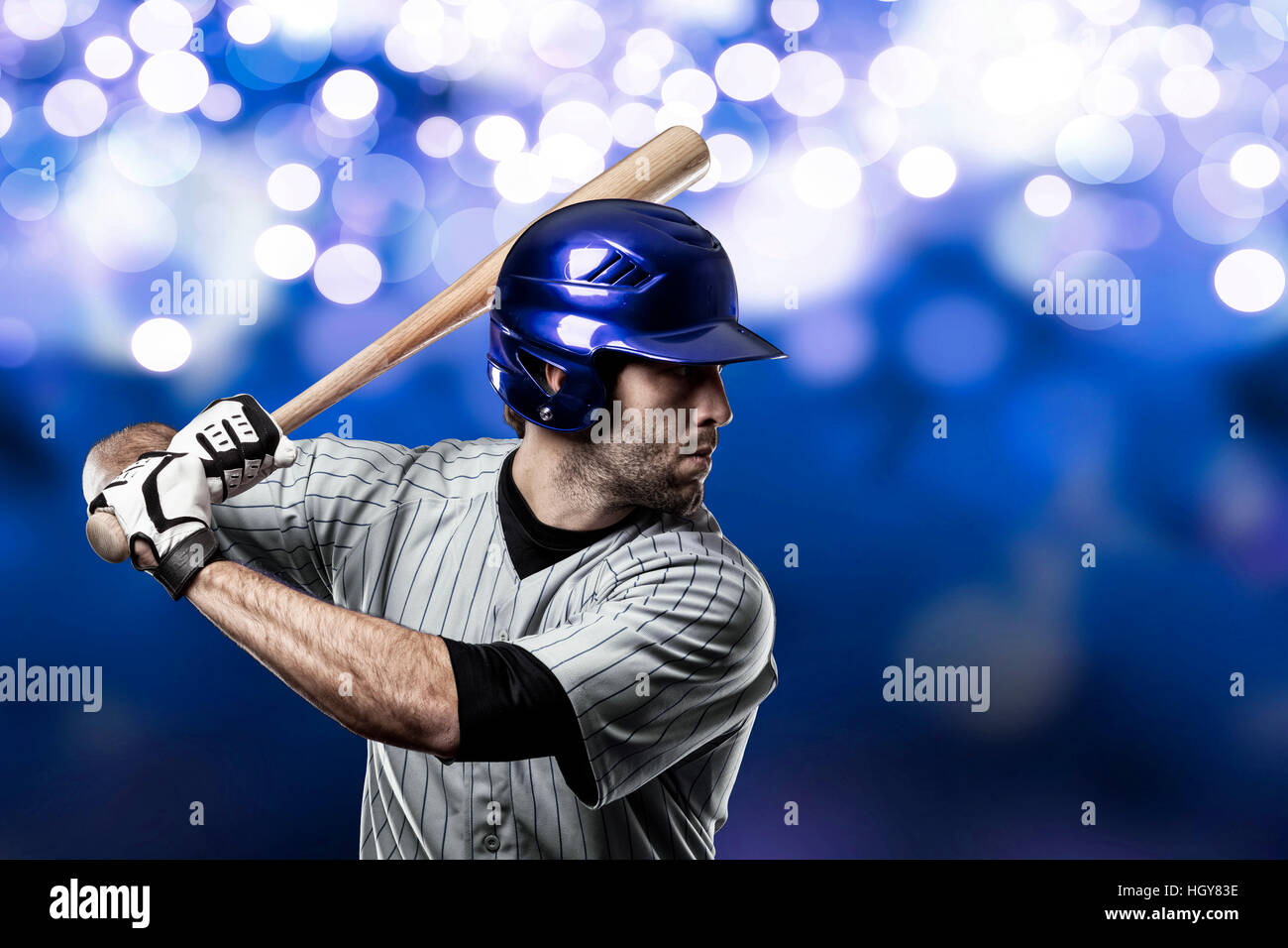 Baseball Player on a Blue Uniform on blue lights background Stock Photo ...