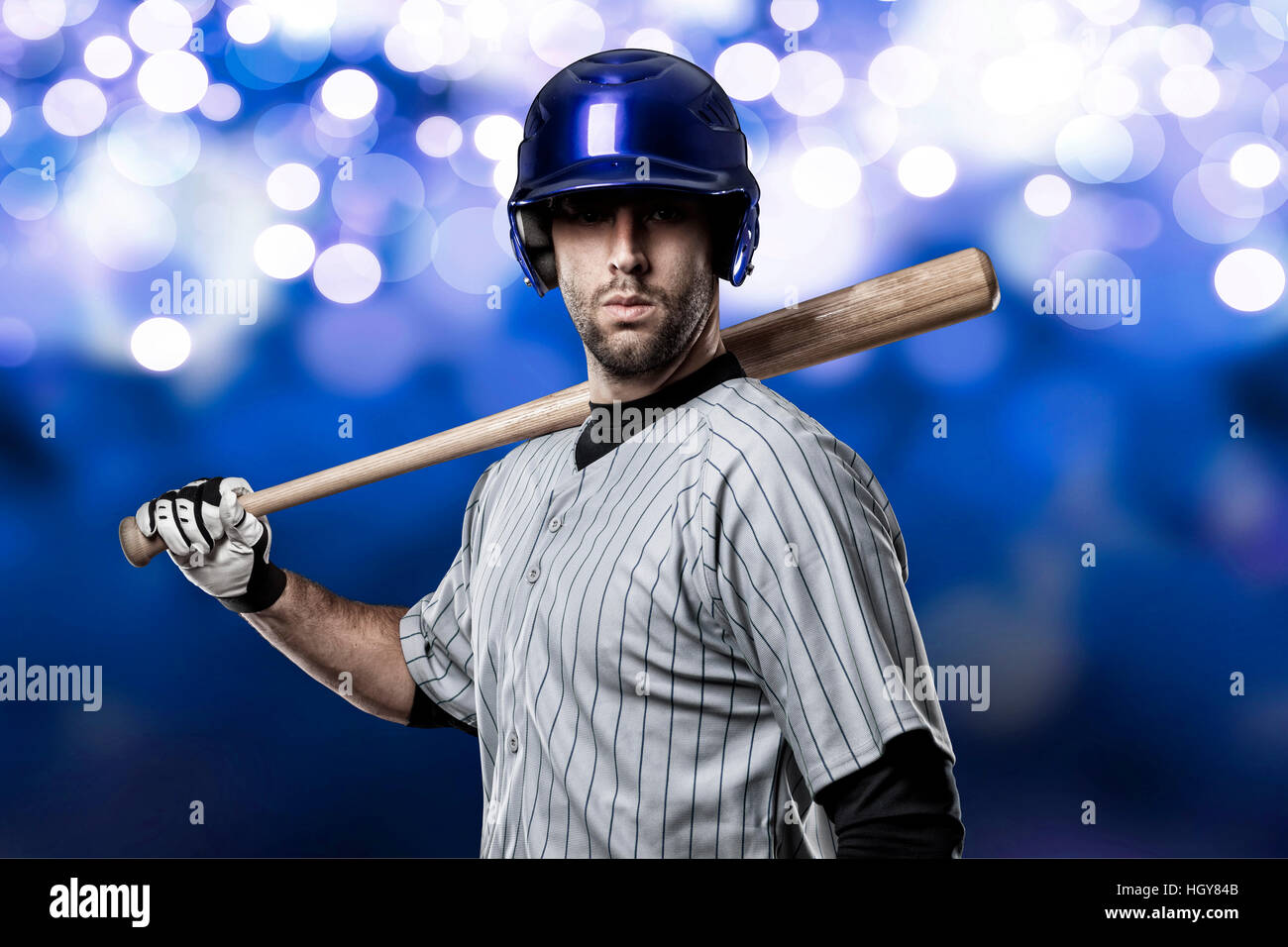 Baseball Player on a Blue Uniform on blue lights background Stock Photo ...