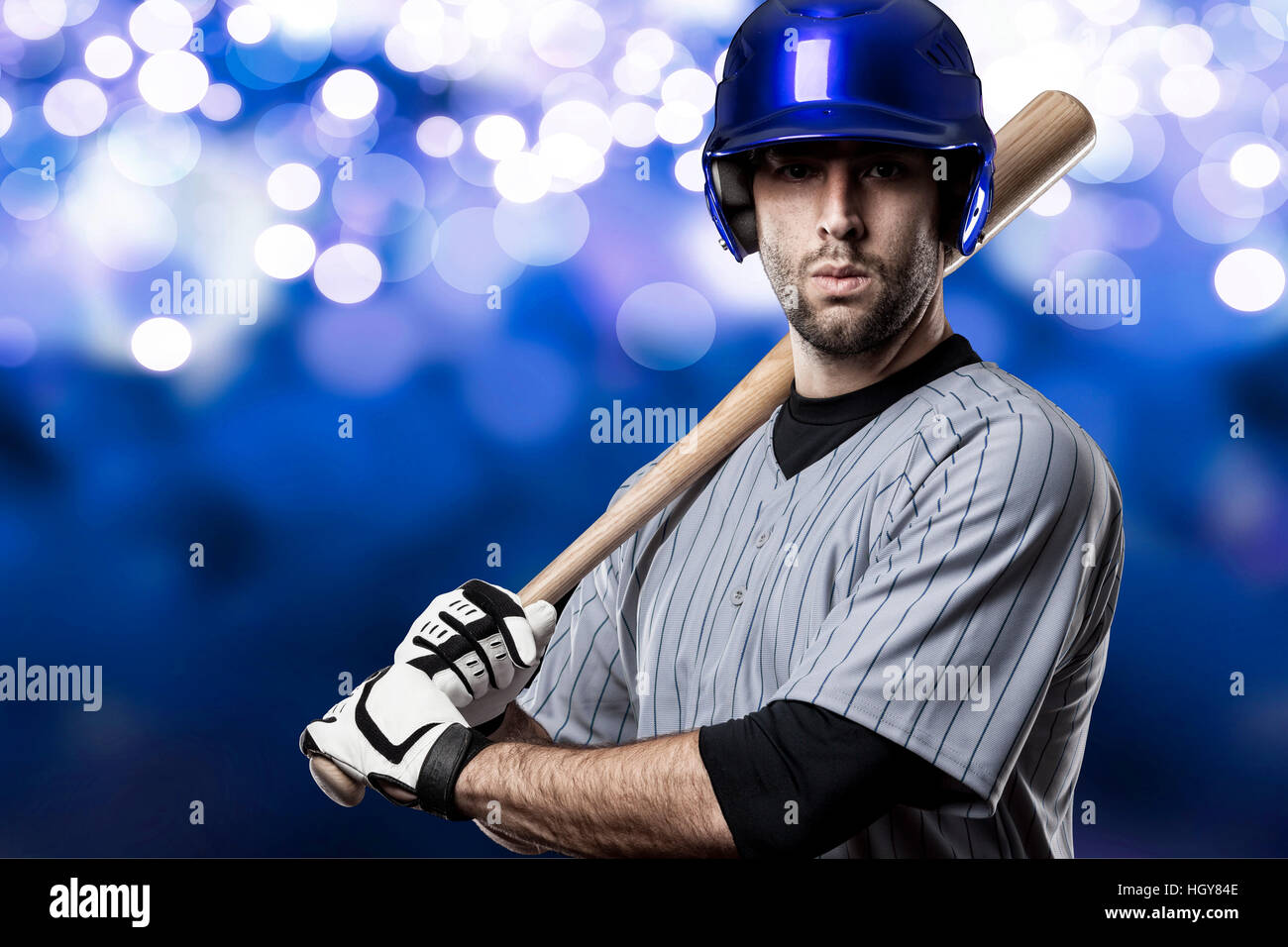 Baseball Player on a Blue Uniform on blue lights background Stock Photo ...