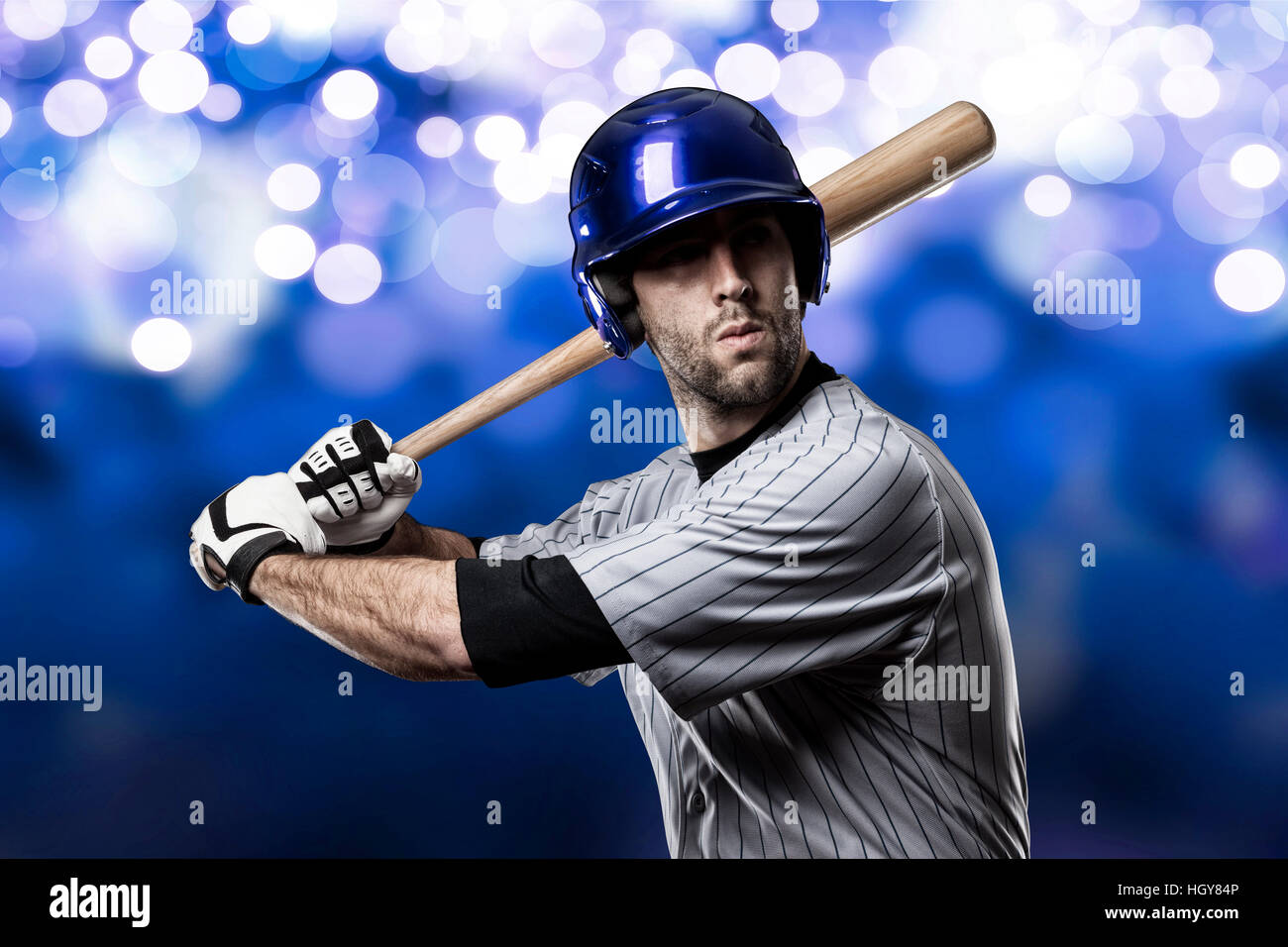 Baseball Player on a Blue Uniform on blue lights background Stock Photo ...