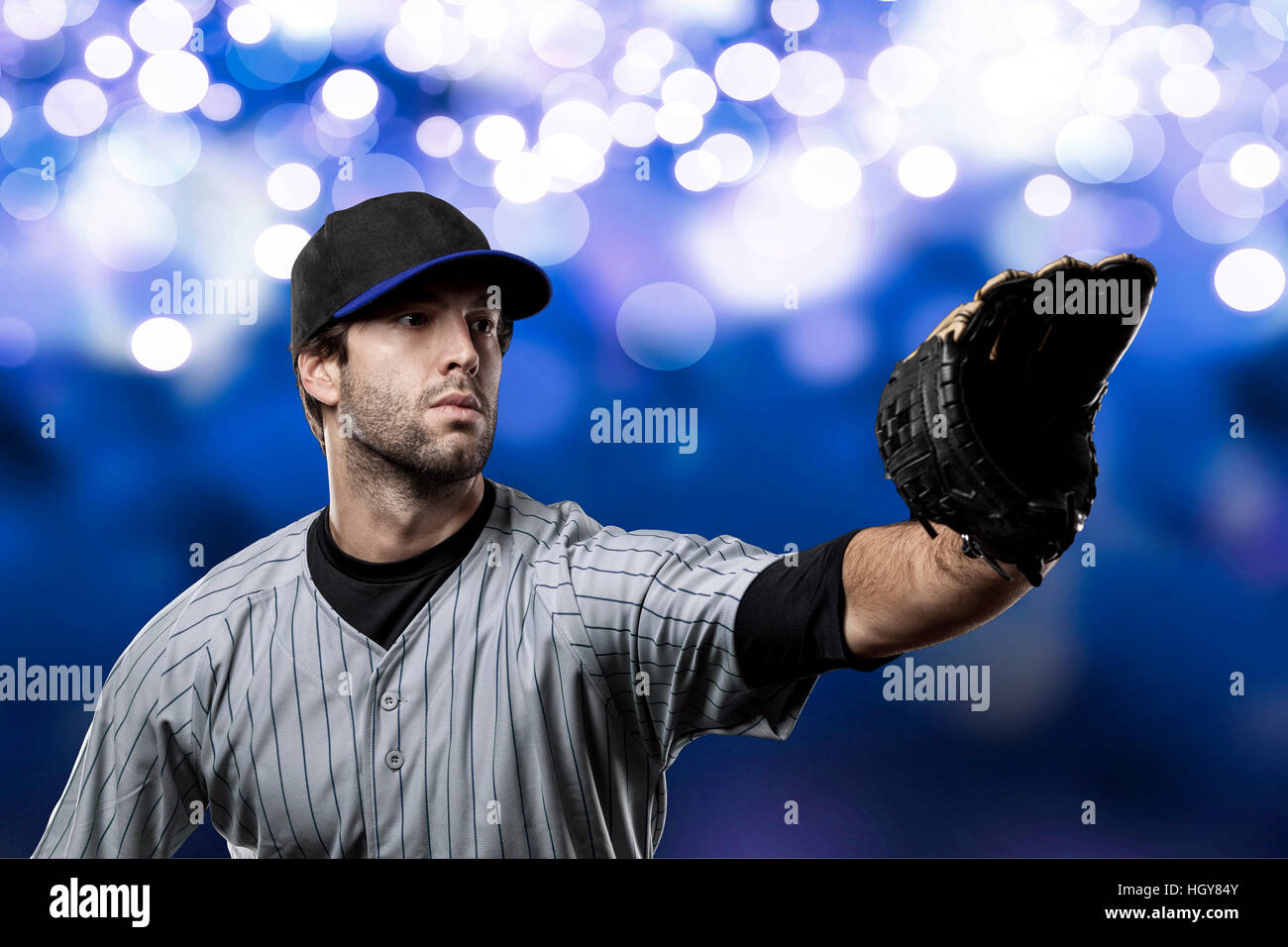 Baseball Player on a Blue Uniform on blue lights background Stock Photo ...
