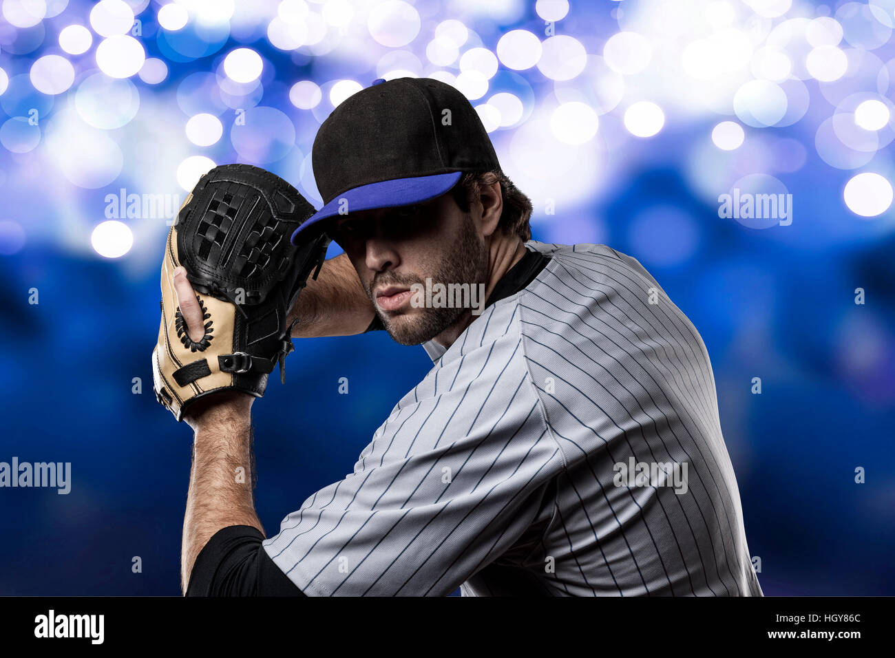 Baseball Player on a Blue Uniform on blue lights background Stock Photo ...