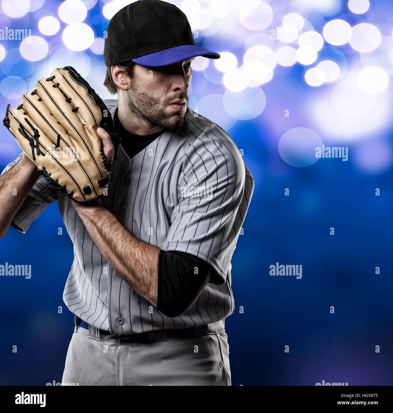 Baseball Player on a Blue Uniform on blue lights background Stock Photo ...