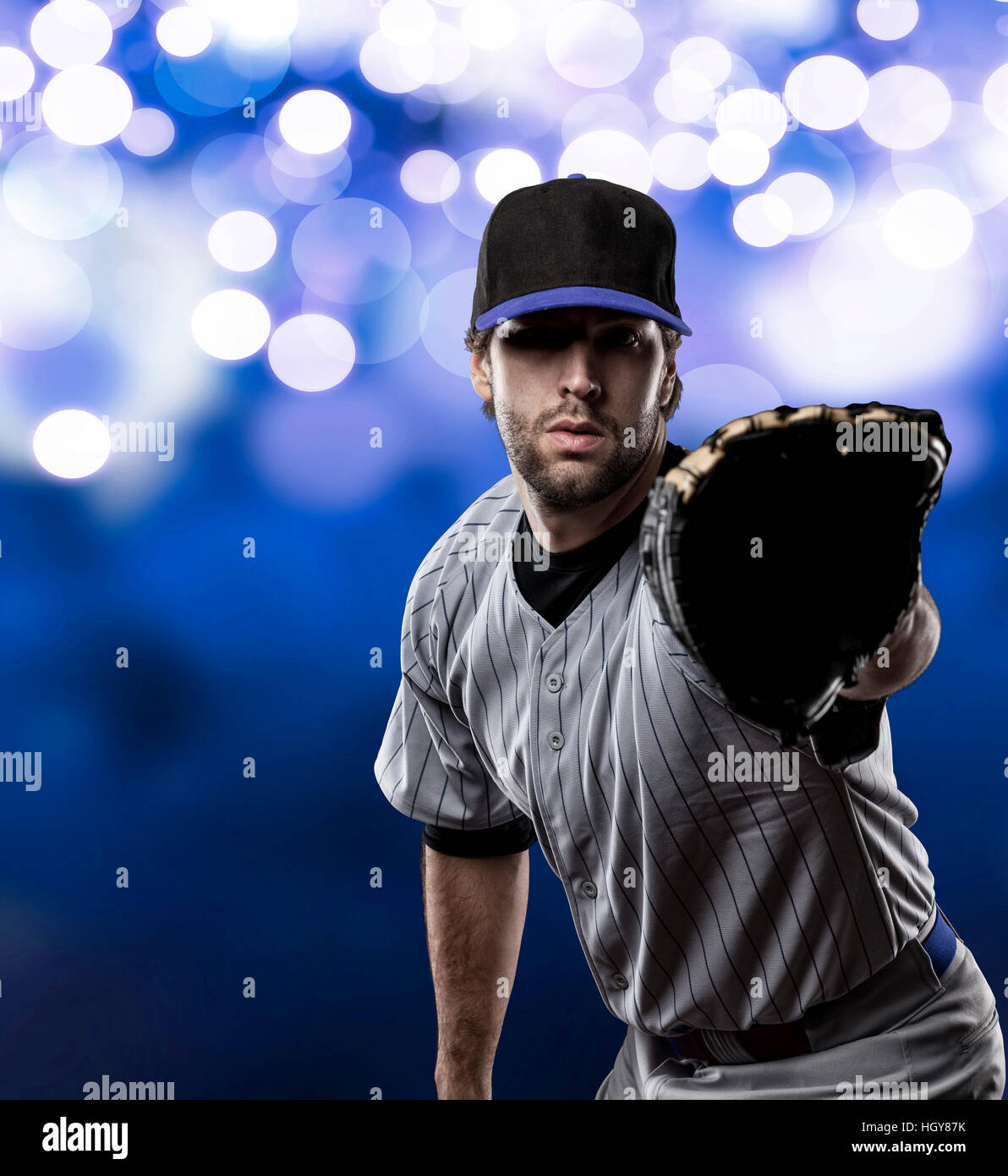 Baseball Player on a Blue Uniform on blue lights background Stock Photo ...