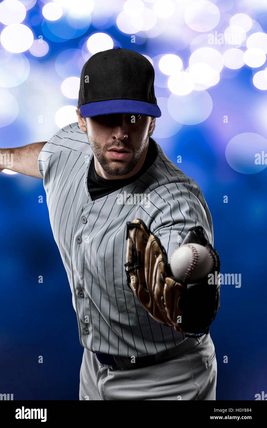 Baseball Player on a Blue Uniform on blue lights background Stock Photo ...