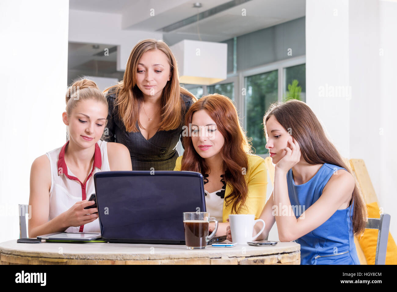 Group of four pretty businesswoman working togeather with new startup ...