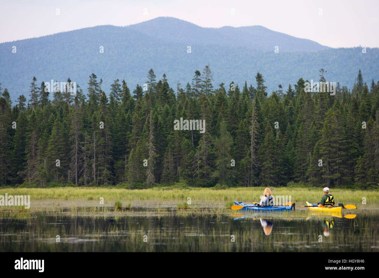 A couple kayaking on East Inlet, Pittsburg, New Hampshire. North of ...