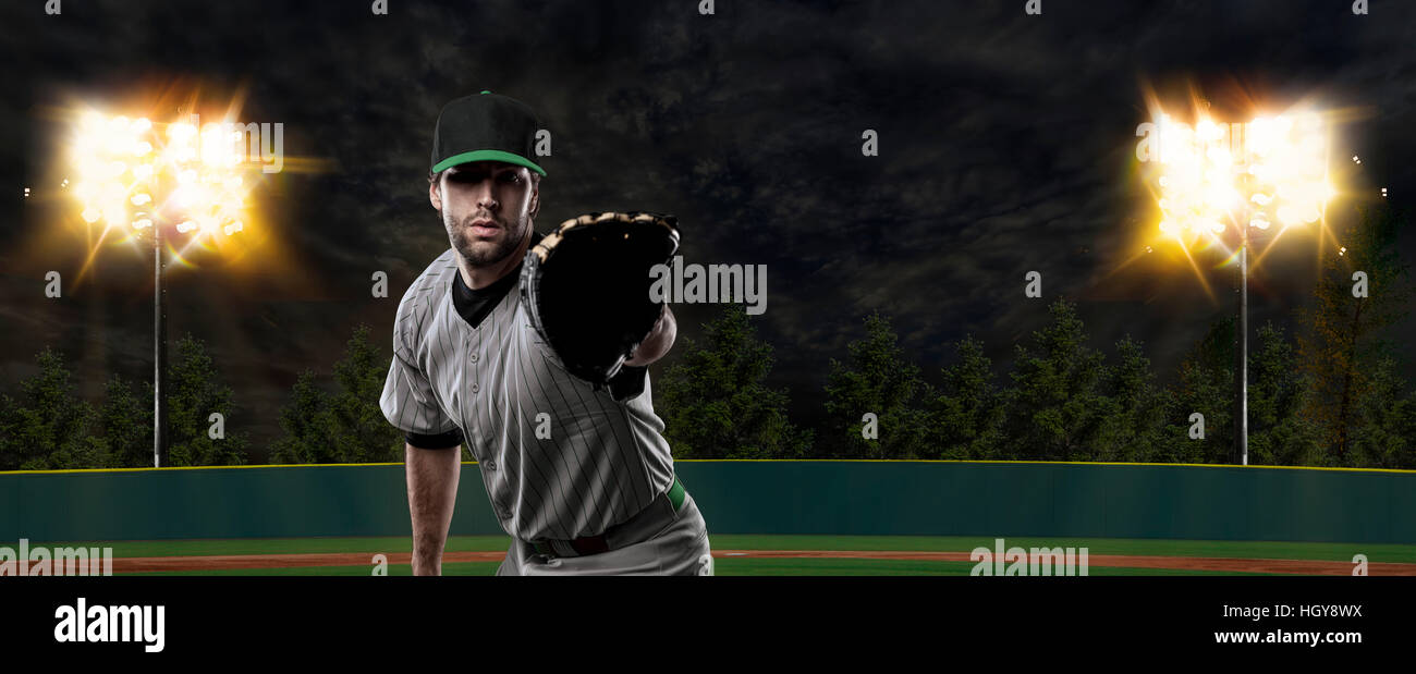 Baseball Player on a Green Uniform on baseball Stadium Stock Photo - Alamy